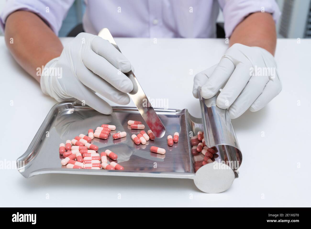 hand of pharmacist count the number of pills to treat the patient in ...