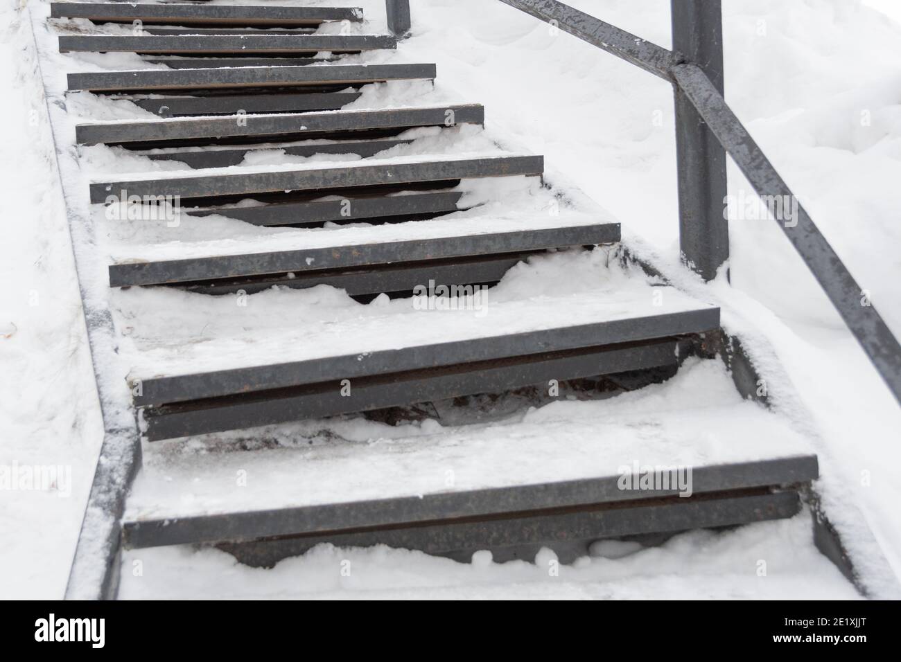 The dangerous staircase is covered with ice and snow. Winter cleaning ...