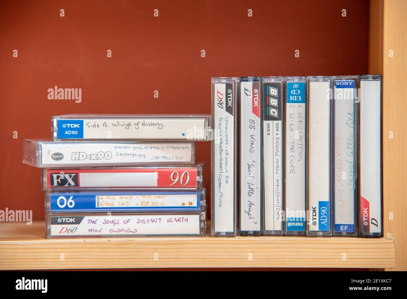 Music cassette mixtapes stacked on a shelf with handwritten labels ...