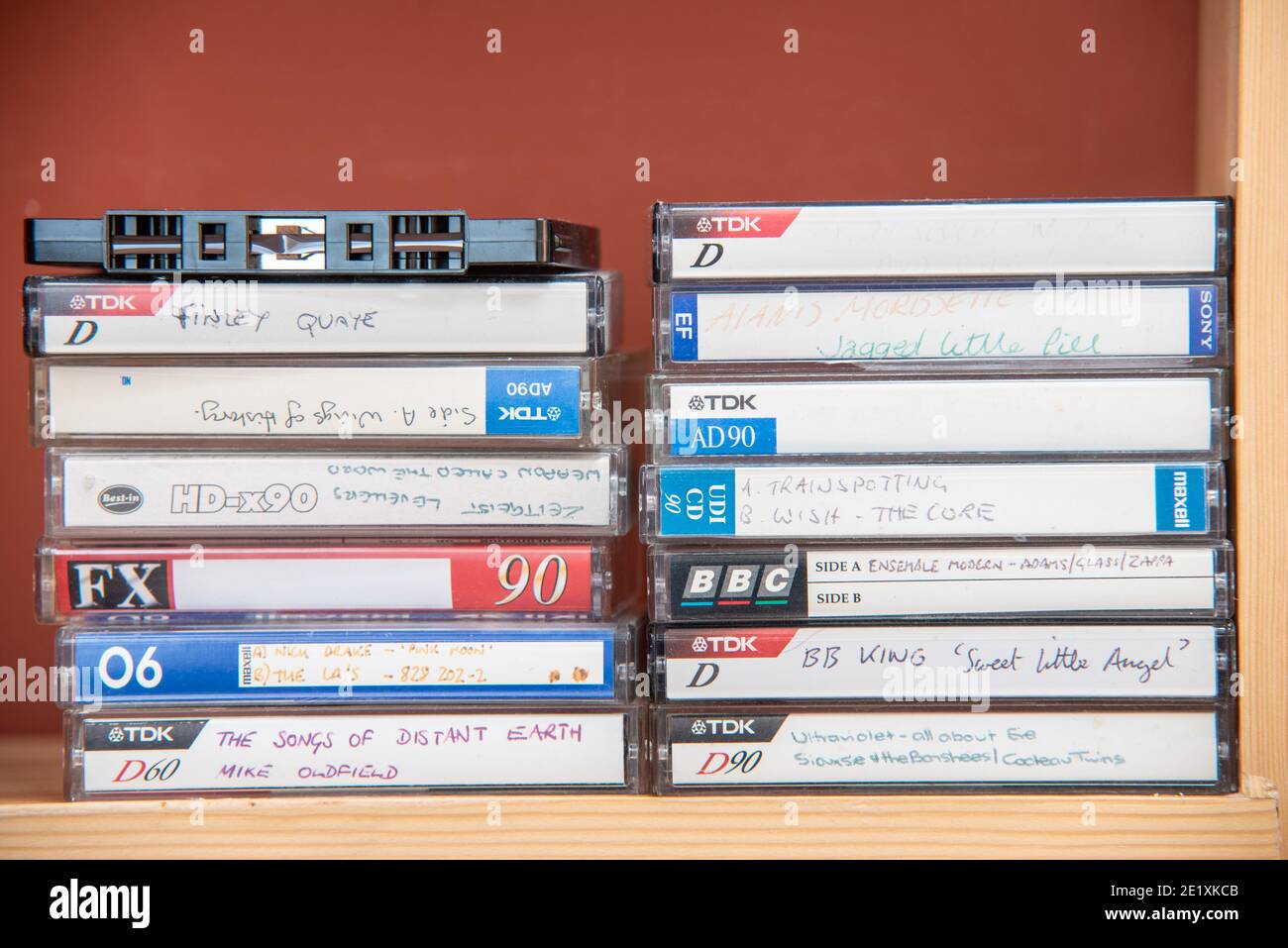 Music cassette mixtapes stacked on a shelf with handwritten labels ...