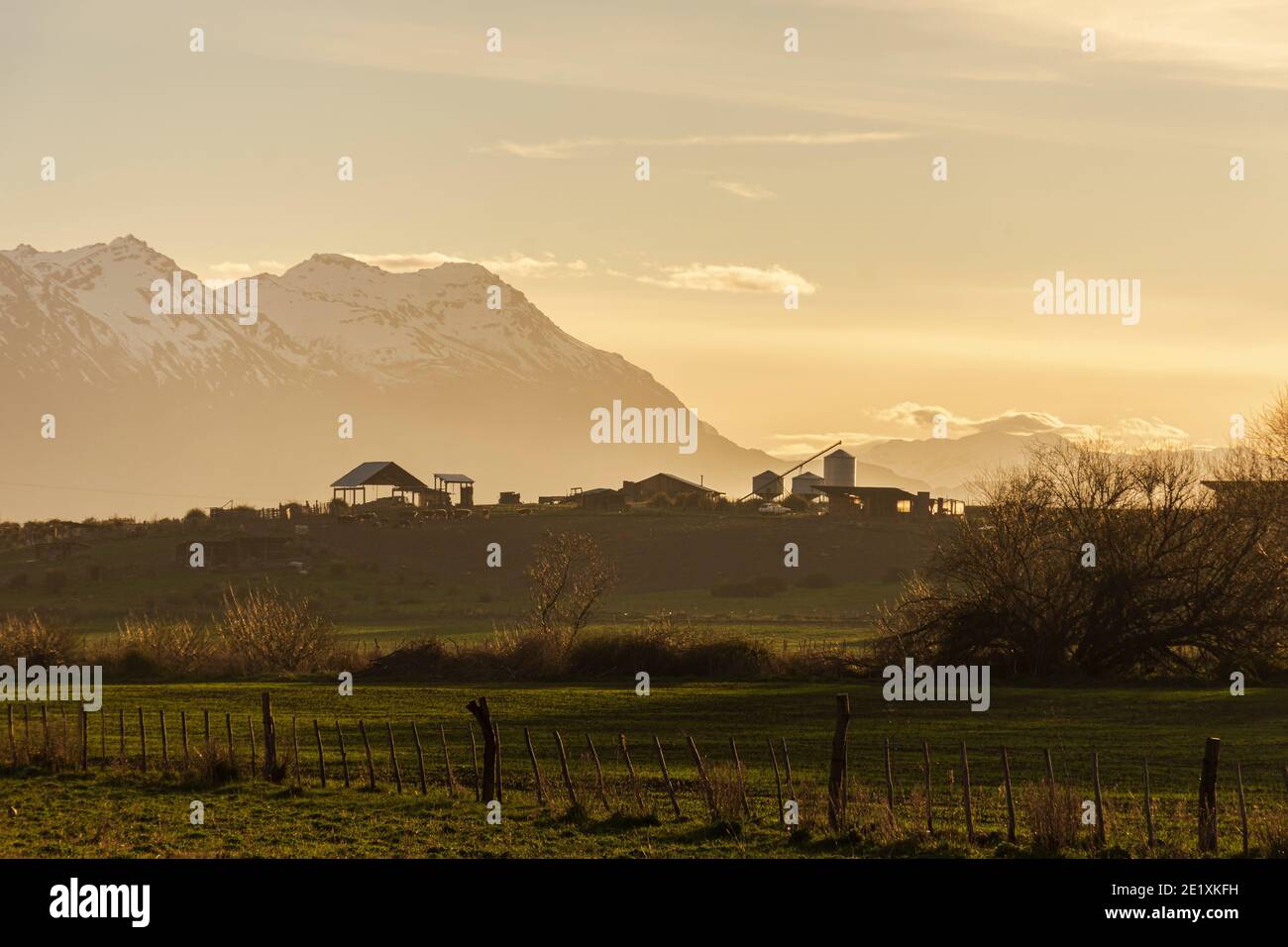 Rural scene of barn and silo in the mountains during sunset in Trevelin ...