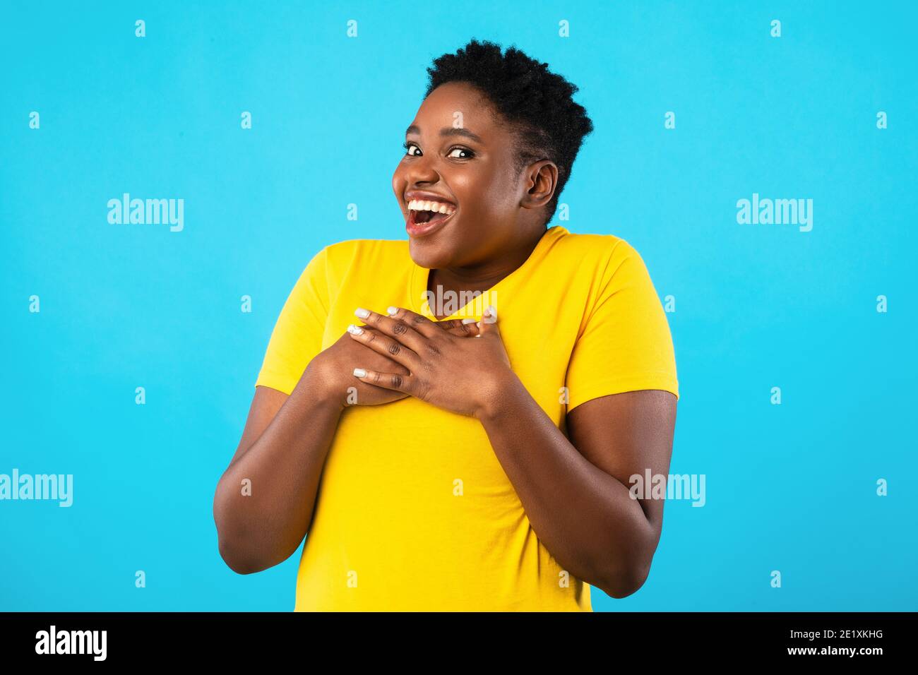 Excited Oversized African Lady Holding Hands On Chest, Blue Background ...