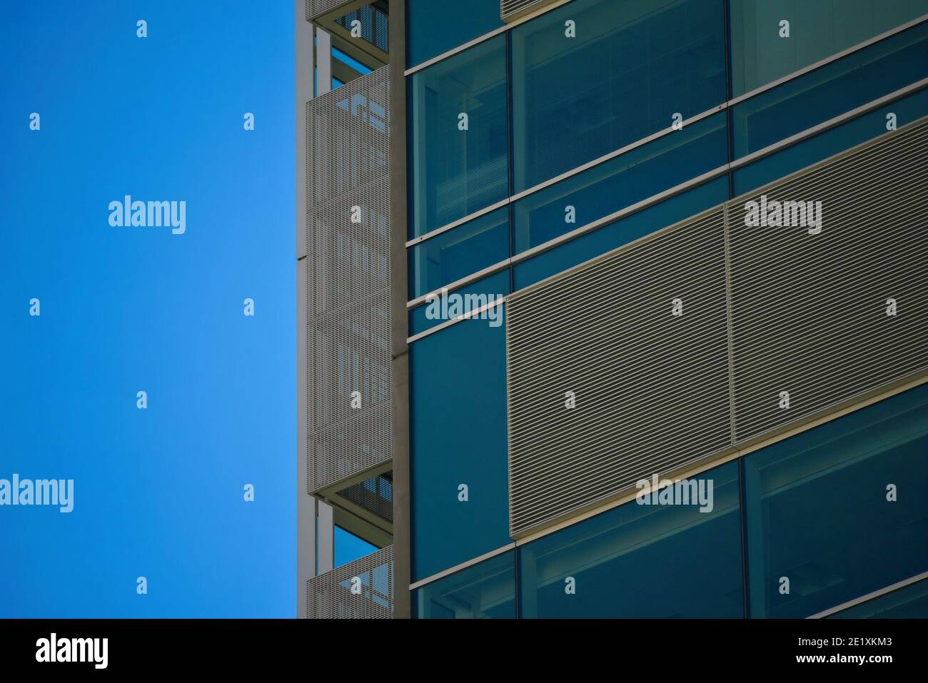 Modern design high-rise building glass facade close-up view against a ...