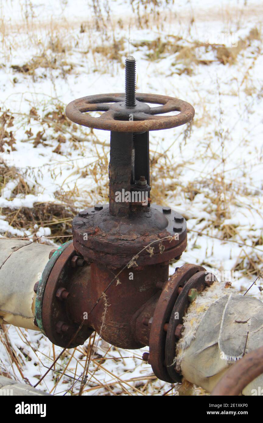 Old damaged and rusty iron oil pipe valve wheel. Metal, pipeline and ...