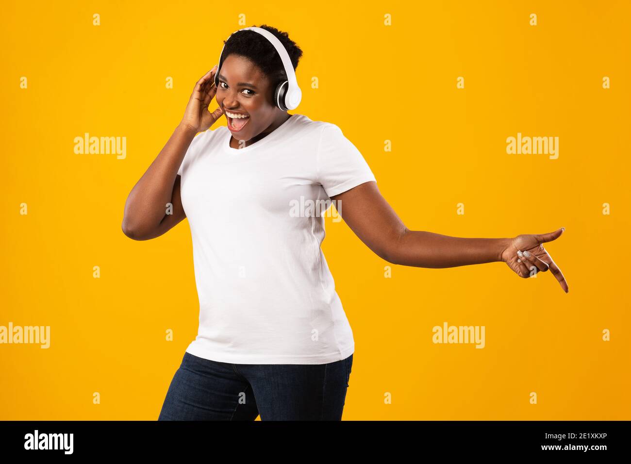 Overweight Black Lady Listening Music In Headphones Over Yellow ...