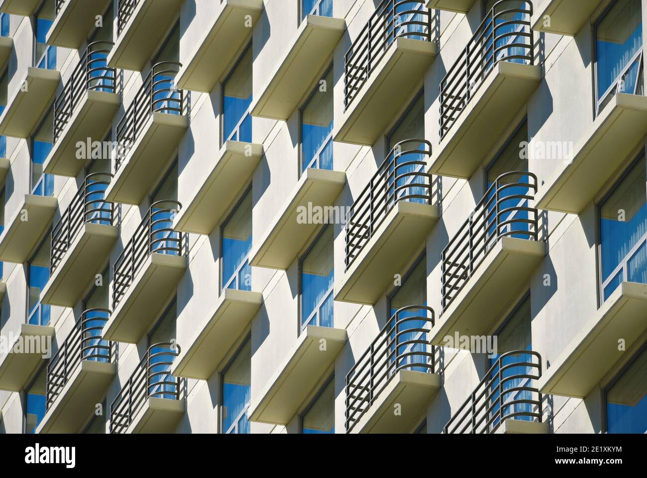 Residential high-rise complex facade view with symmetrical windows and ...