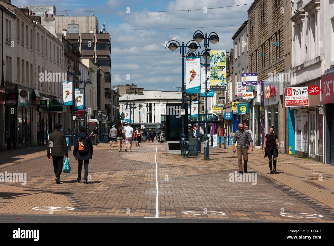 Huddersfield, UK - July 12 2020: People follow a one-way system in ...
