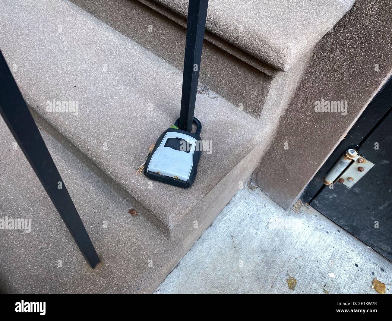 Closed lock on cement step fastened around a steel bar that supports a ...