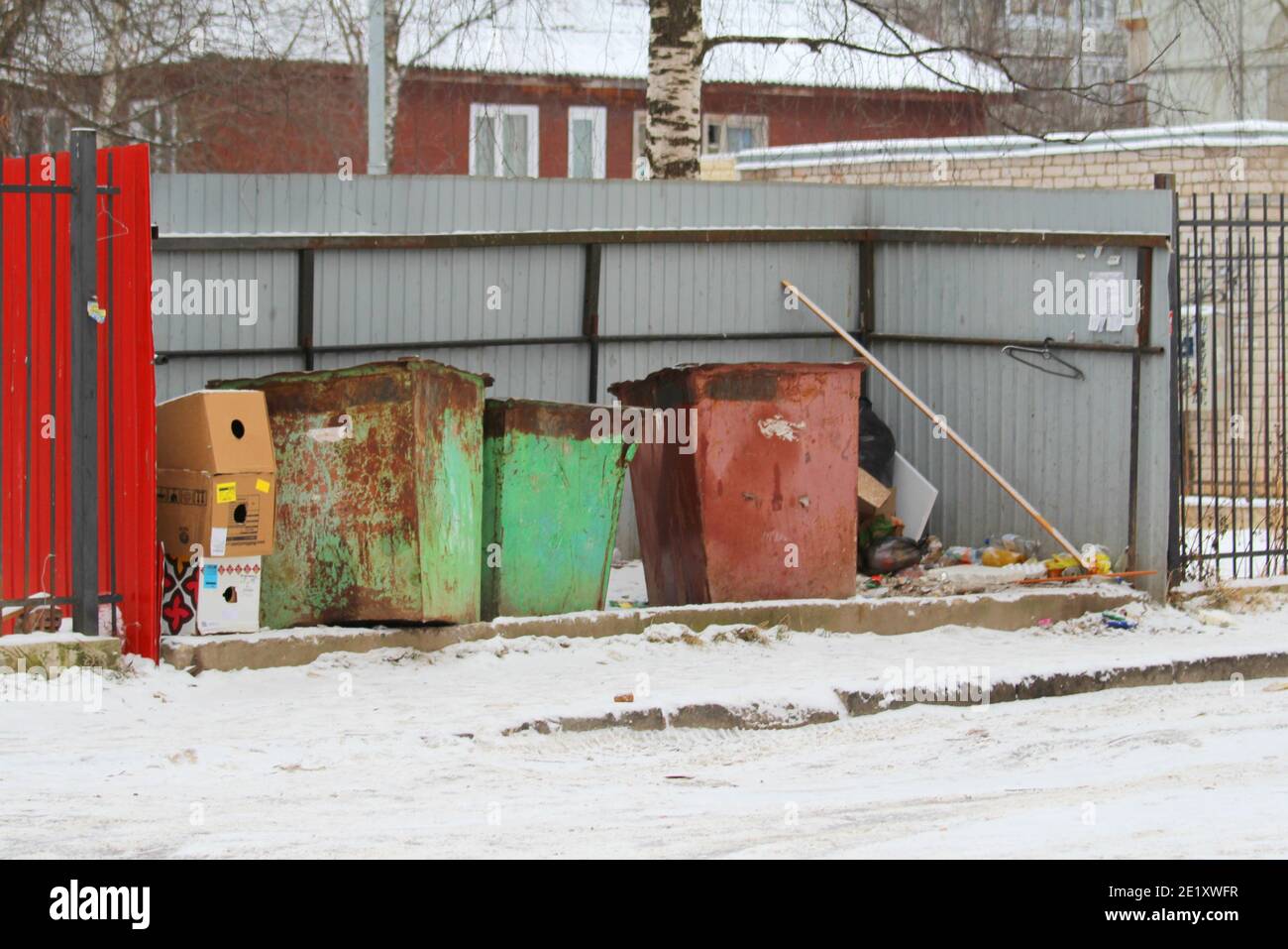 Old rusty street garbage containers of green and red colors. Waste ...