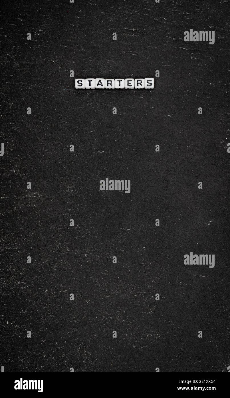 Word starters on black stone background Stock Photo - Alamy