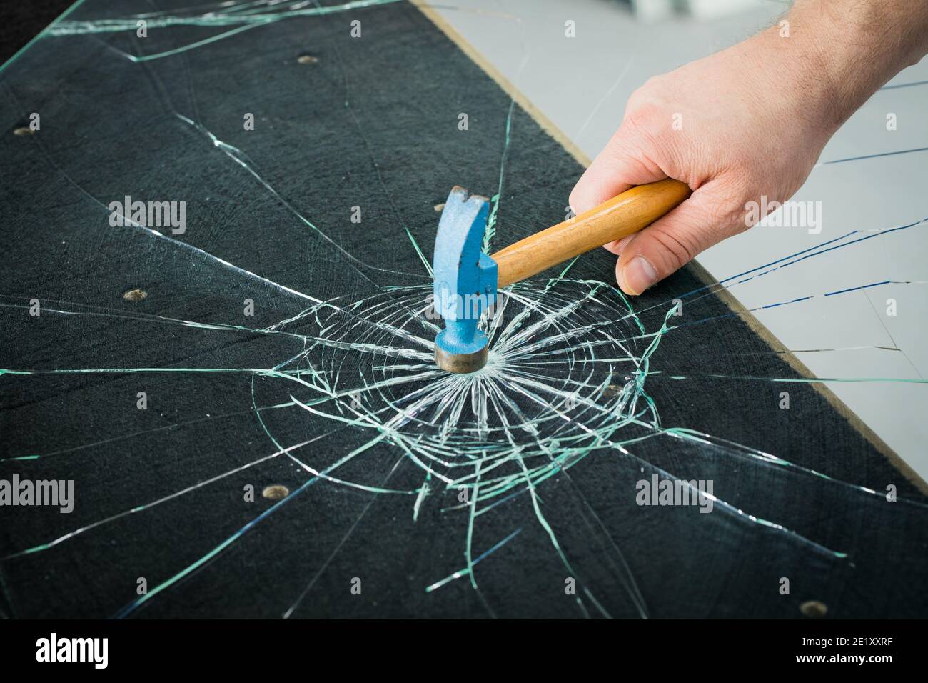 breaking safety glass with a hammer Stock Photo - Alamy