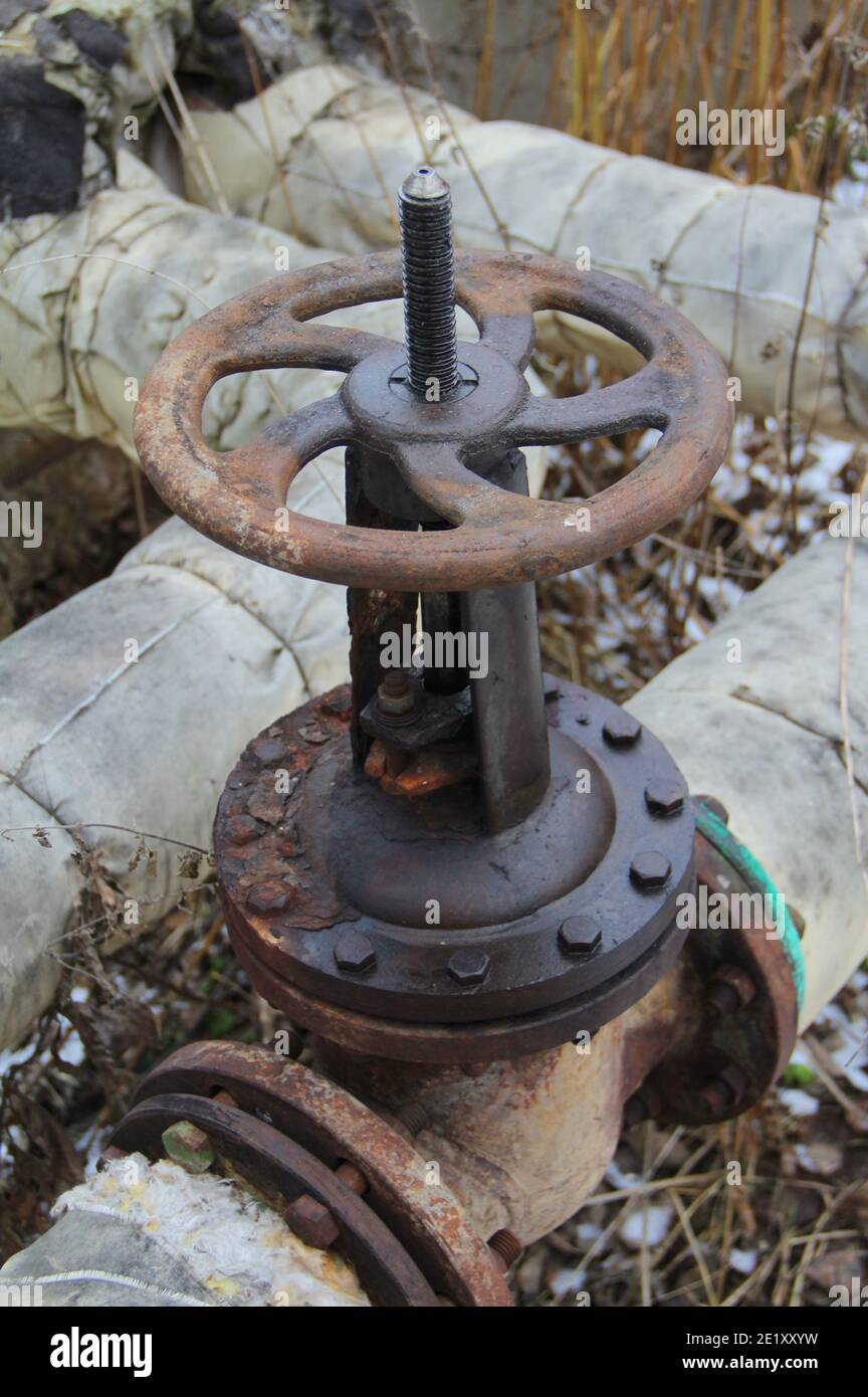 Old damaged and rusty iron oil pipe valve wheel. Metal, pipeline and ...