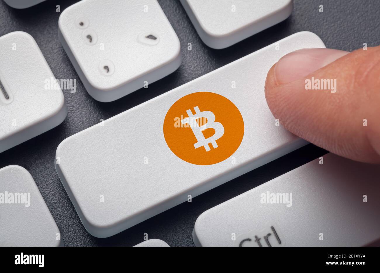 finger pressing computer key bitcoin symbol. crypto mining concept ...