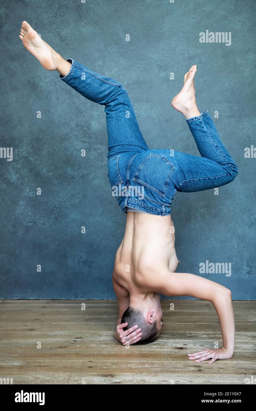 Non binary, biologically female individual with shaved head in yoga ...