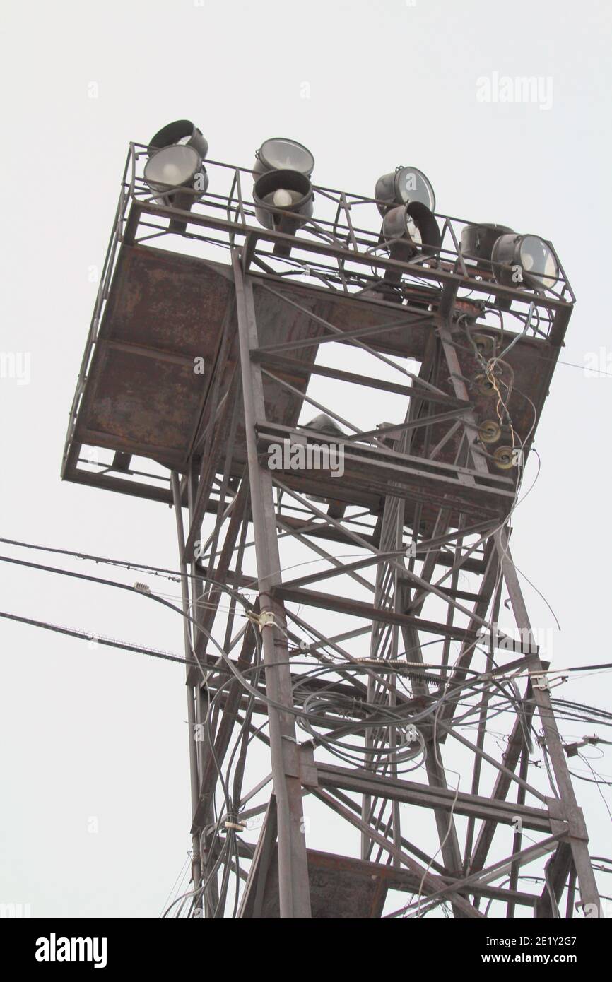 Metal construction with spotlights on top on cloud sky background ...