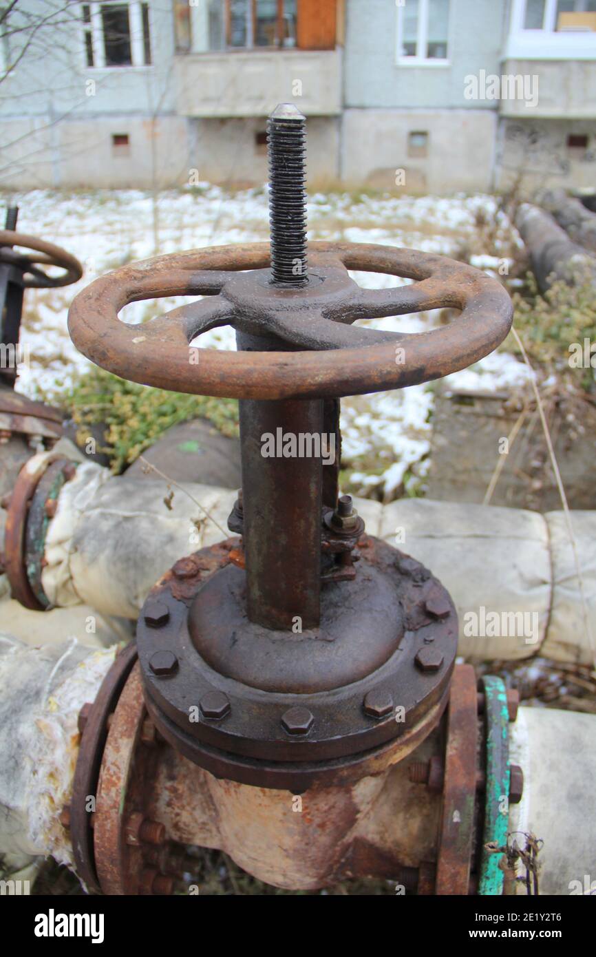 Old damaged and rusty iron oil pipe valve wheel. Metal, pipeline and ...