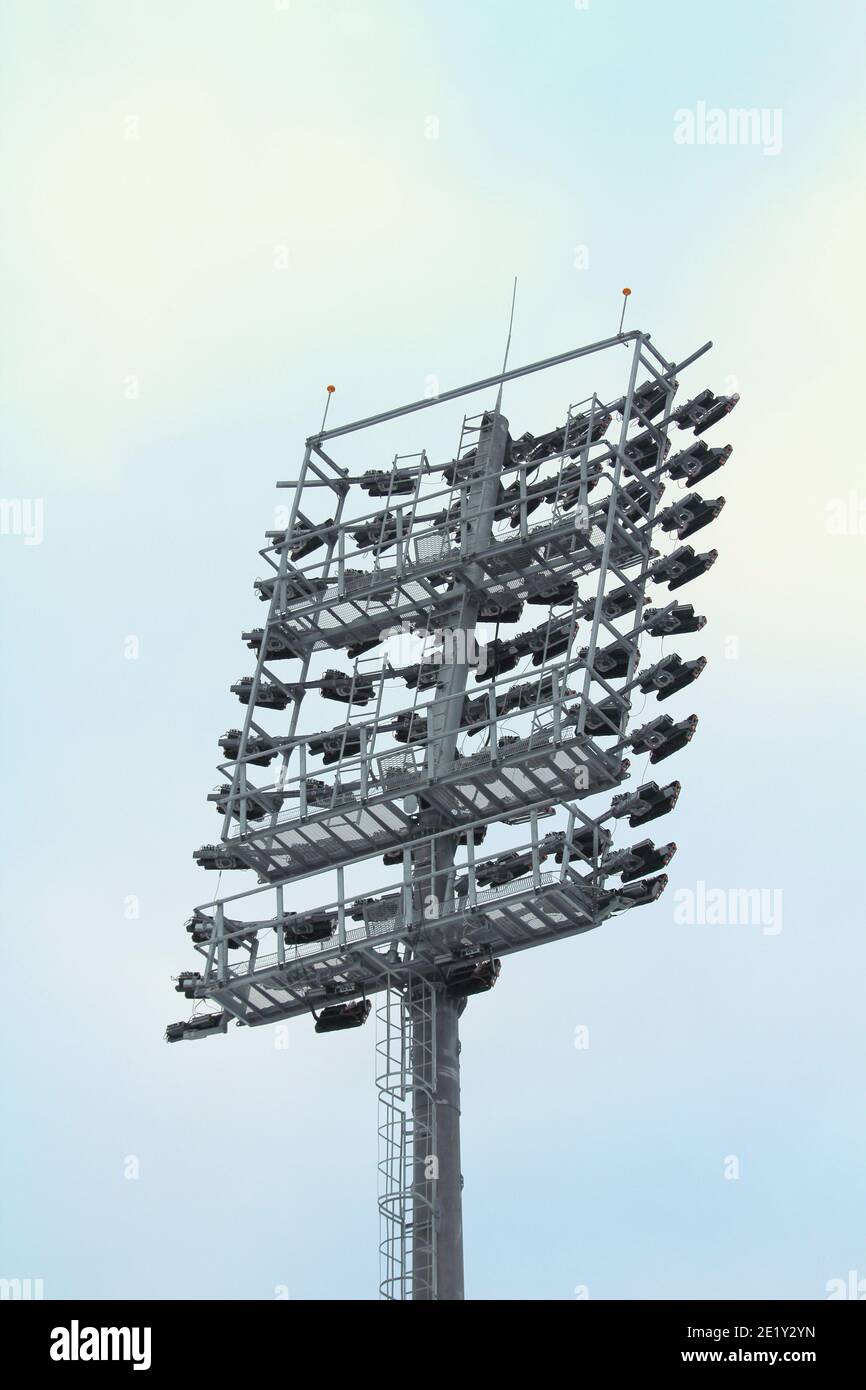Spotlight on a sports stadium on blue sky background, daylight, close ...