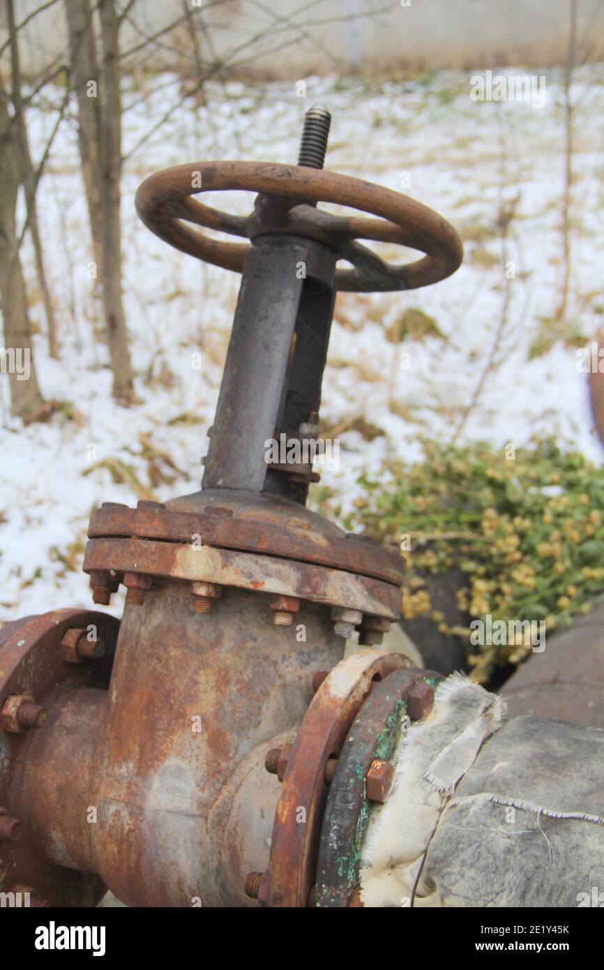 Old damaged and rusty iron oil pipe valve wheel. Metal, pipeline and ...