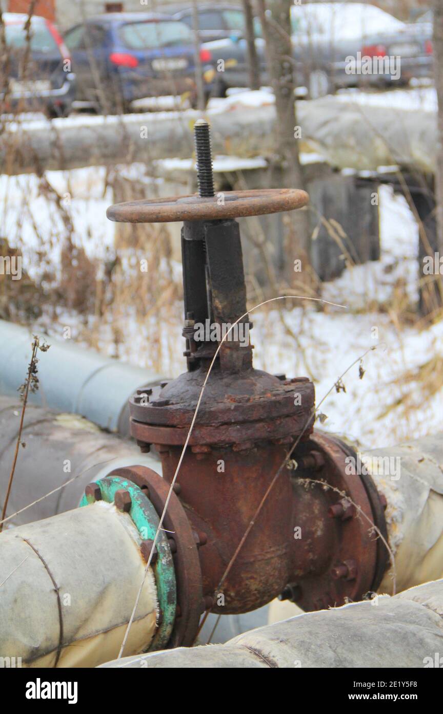 Old damaged and rusty iron oil pipe valve wheel. Metal, pipeline and ...