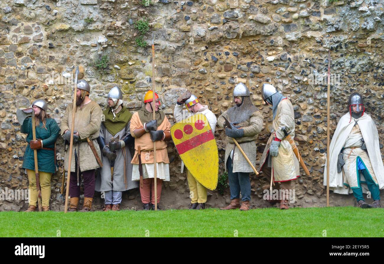 Medieval men at arms against old wall Stock Photo - Alamy