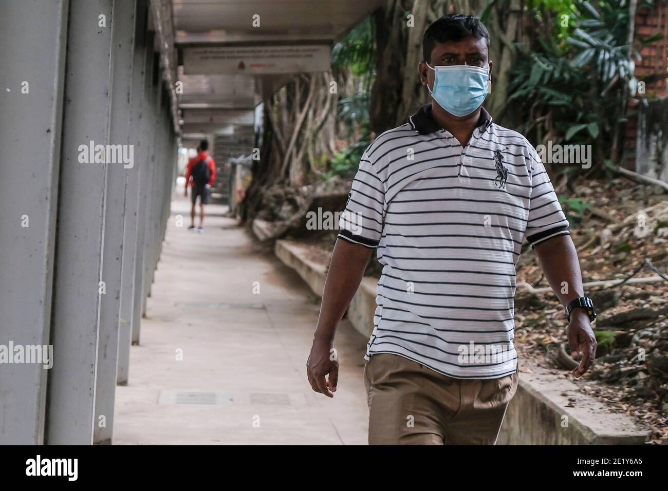 A man wearing a face mask as a precaution against the spread of Covid ...