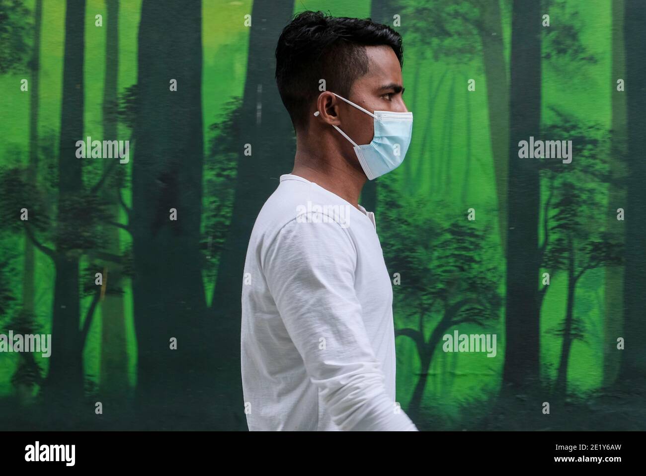 A man wearing a face mask as a precaution against the spread of Covid ...