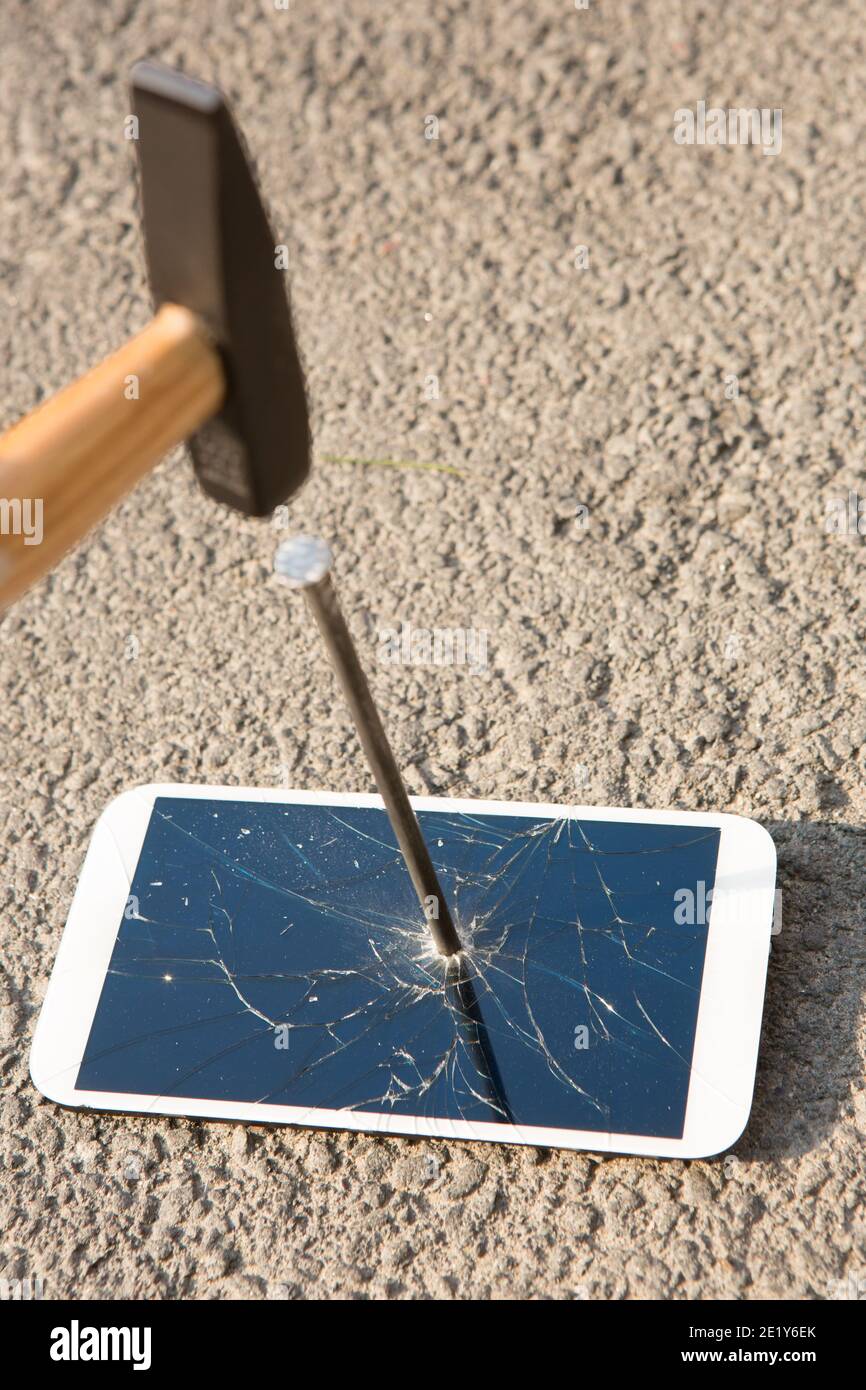 hammer smashing the screen of a smartphone Stock Photo - Alamy
