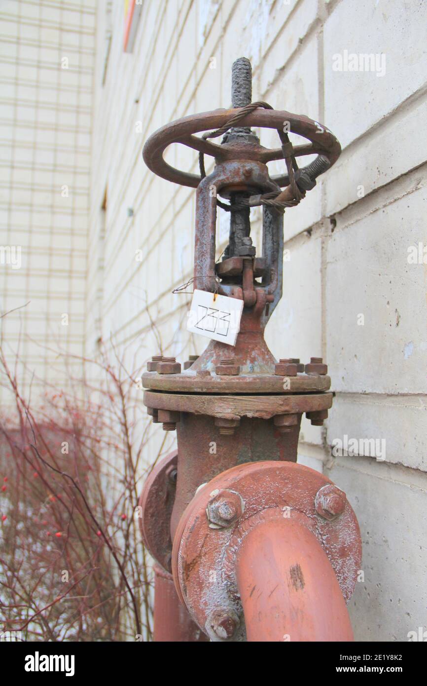 Old damaged and rusty iron oil pipe valve wheel. Metal, pipeline and ...