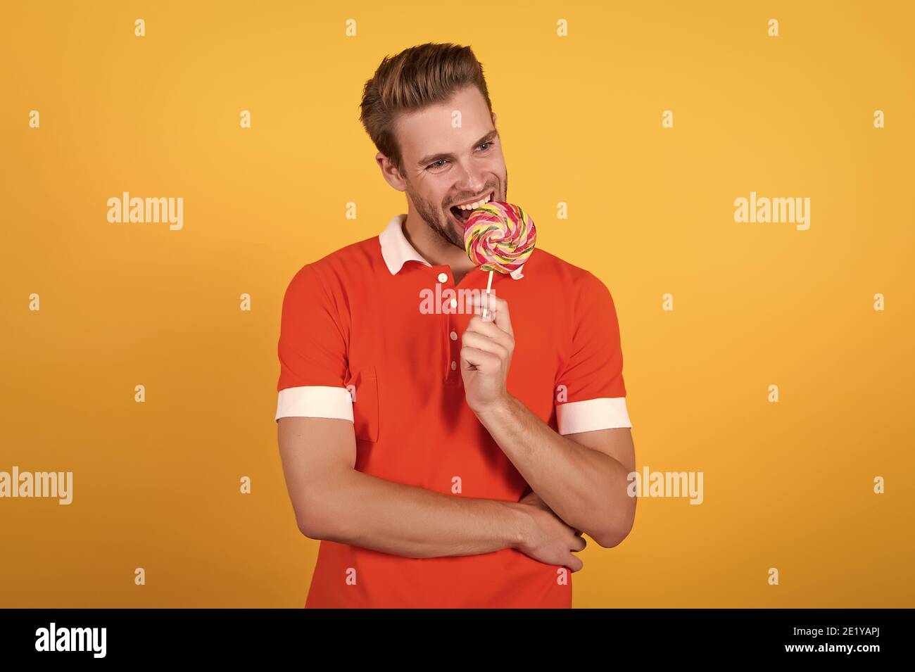 Nothing works better than dessert. Happy man bite candy dessert on ...