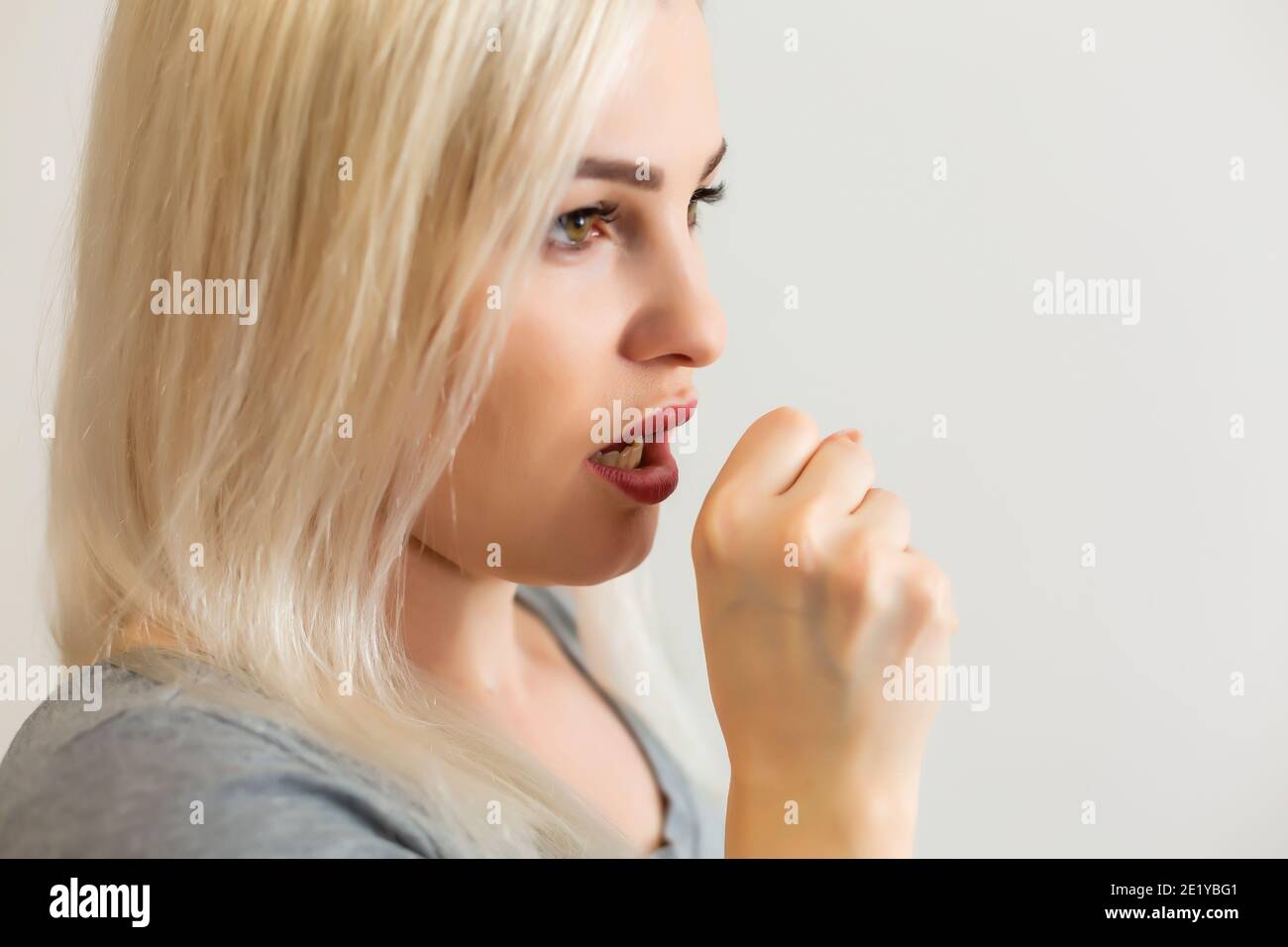 Pretty blond girl coughing, ill Stock Photo - Alamy