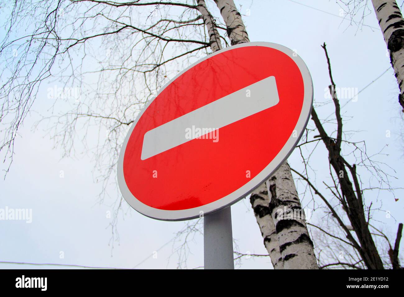 Red round road sign with white stripe prohibiting movement against the ...