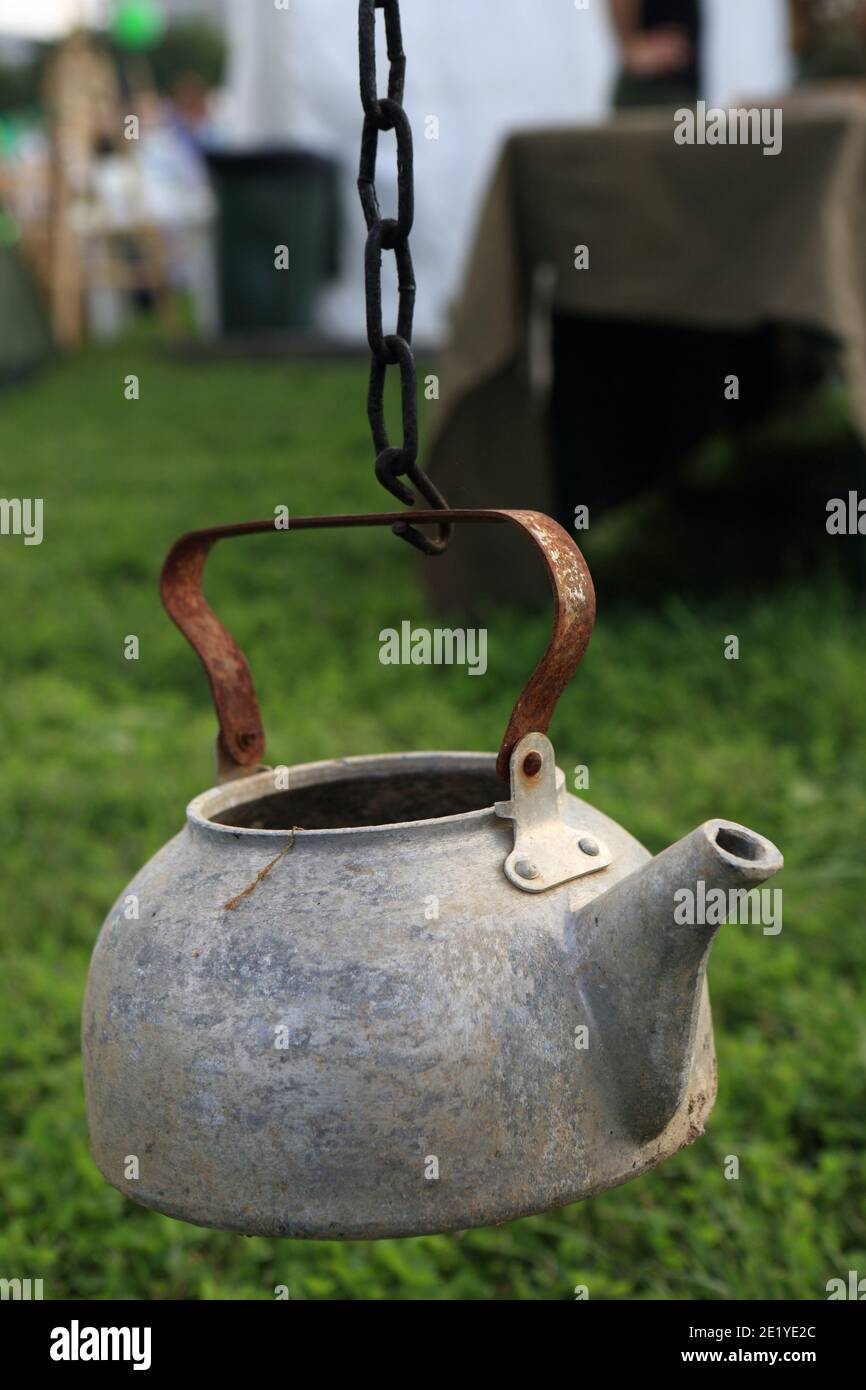 Old rusty kettle hanging on a chain in park at picnic Stock Photo - Alamy