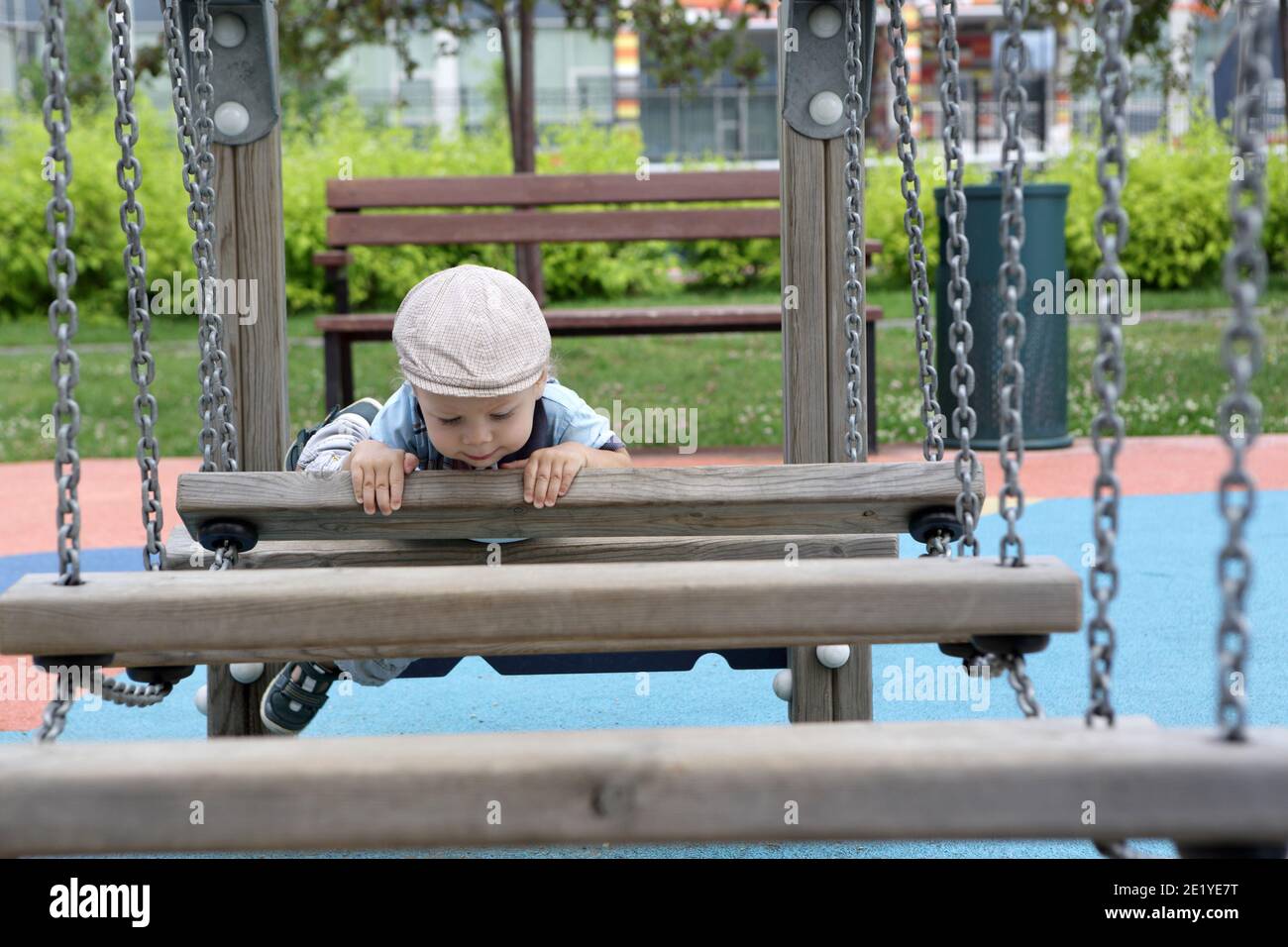 Toddler climbing wooden obstacle at an playground Stock Photo - Alamy