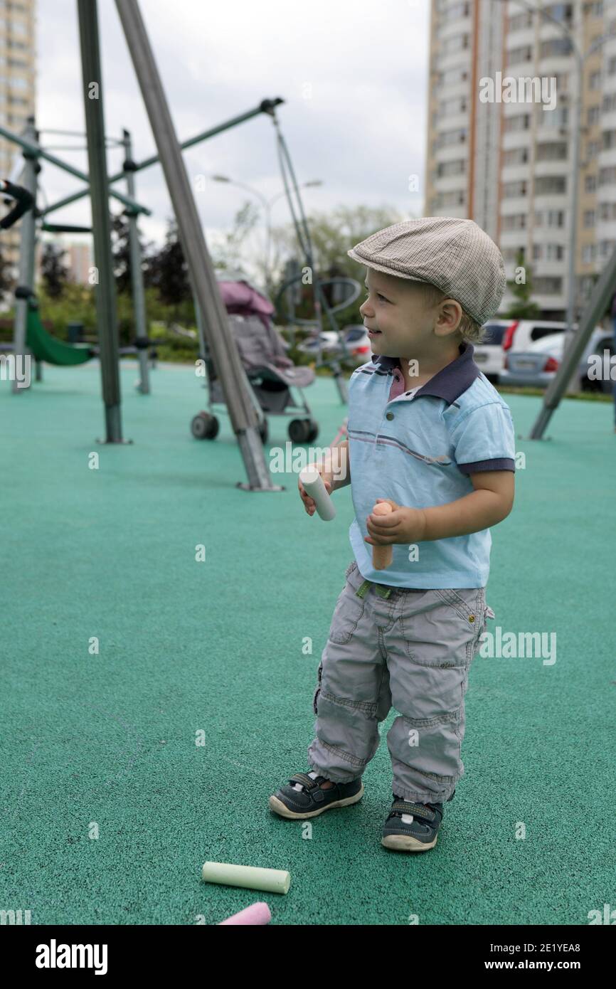 Child with crayons at an outdoor playground Stock Photo - Alamy