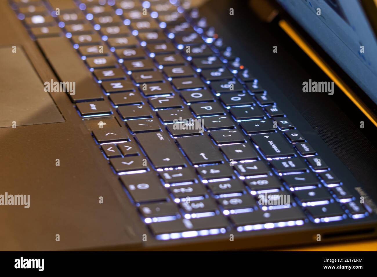 Stock image of a laptop keyboard, backlit, with screen on (no visible ...
