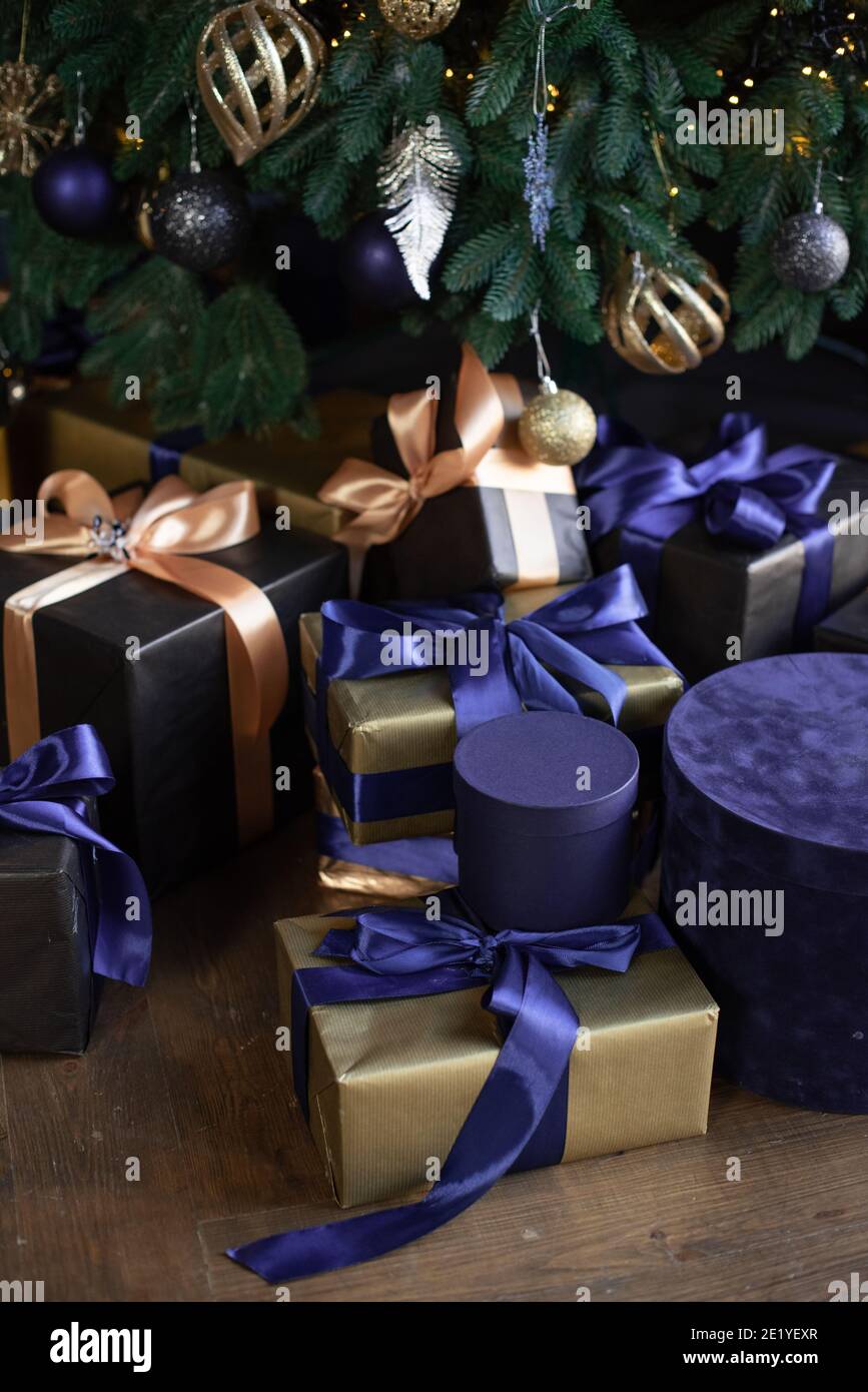 Christmas gifts in beautiful blue and golden boxes. Christmas gift ...