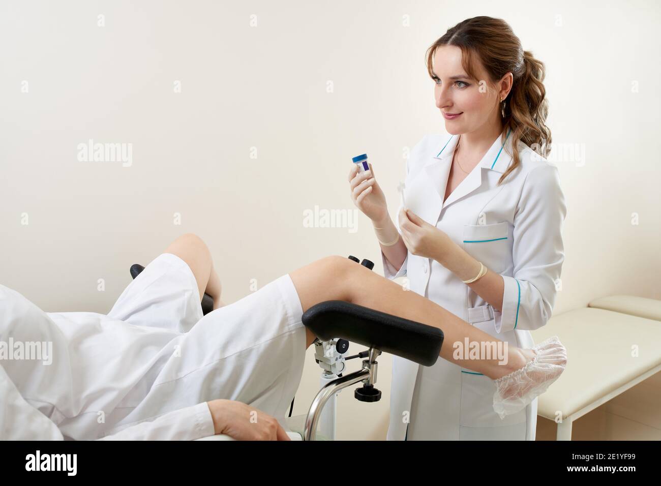 Gynaecologist examining a patient sitting on gynecological chair Stock ...
