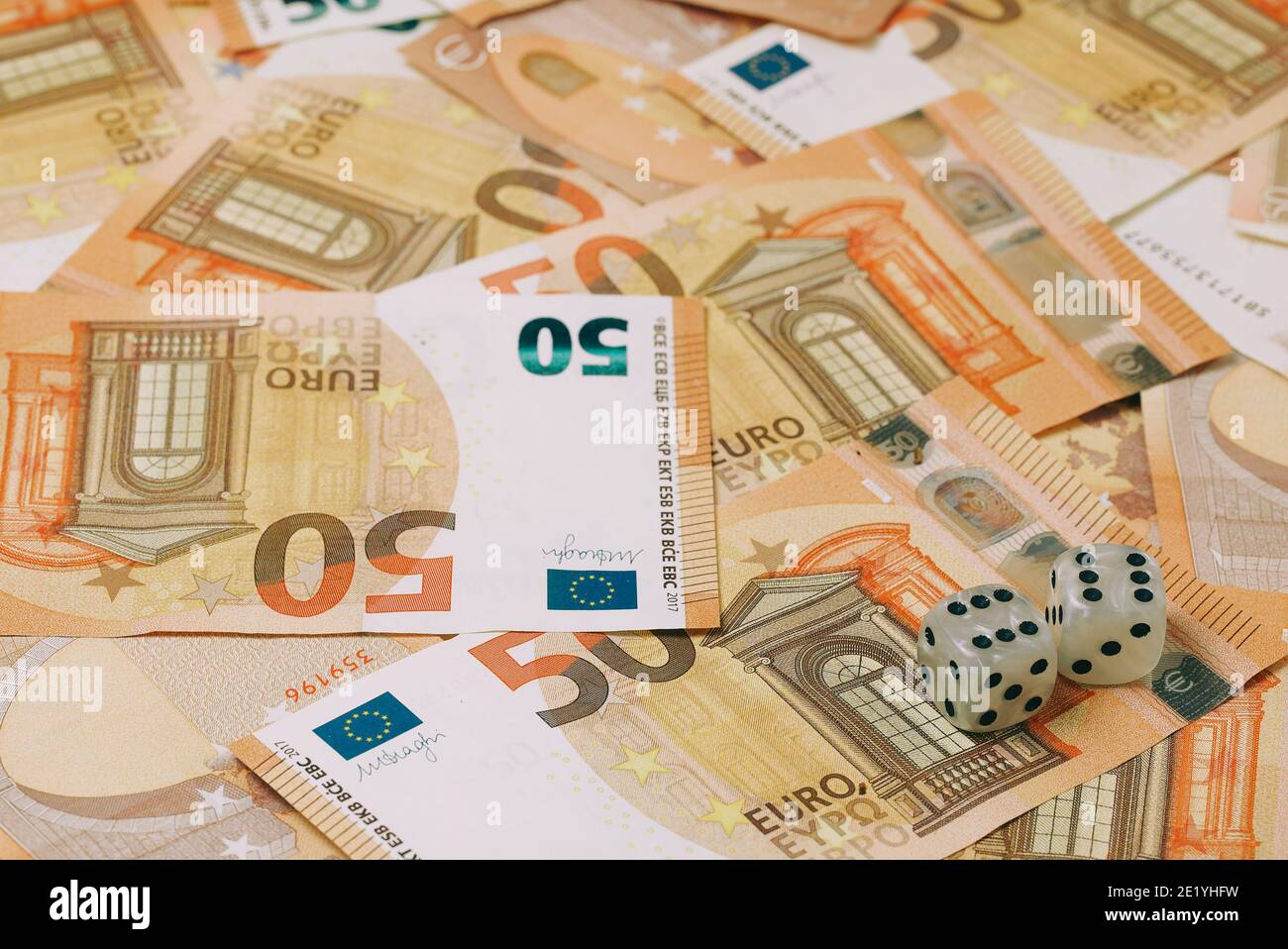 two dice with a score of 6 on a background of euro 50 banknotes Stock ...