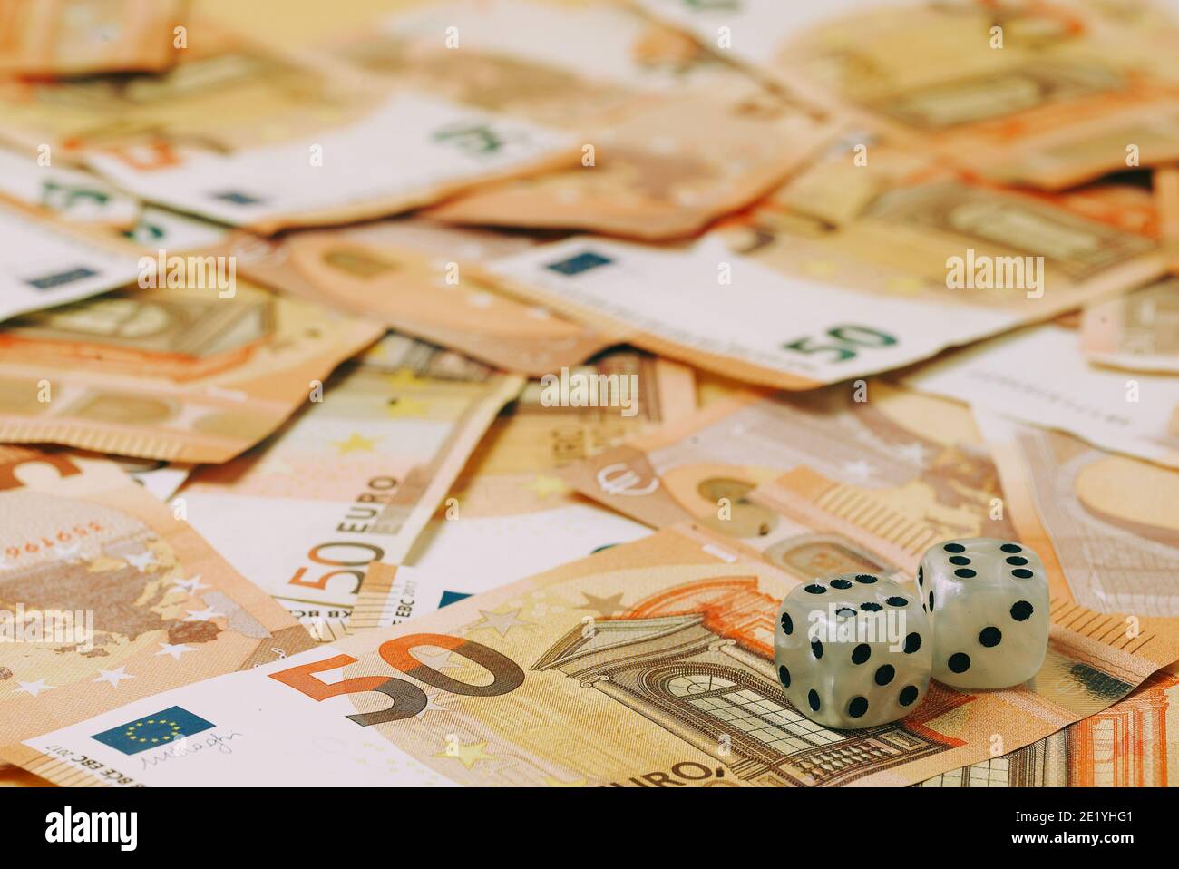 two dice with a score of 6 on a background of euro 50 banknotes Stock ...