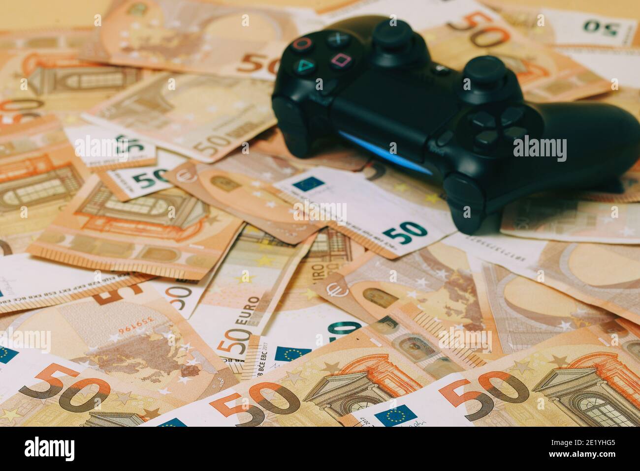 video games, black joypad on banknote background Stock Photo - Alamy