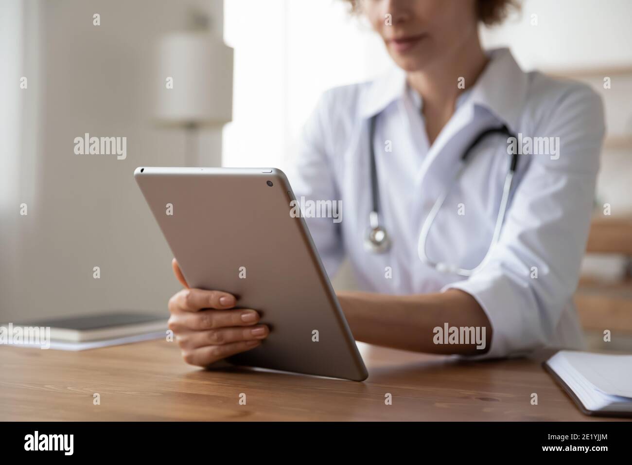 Young female general practitioner using digital computer tablet Stock ...