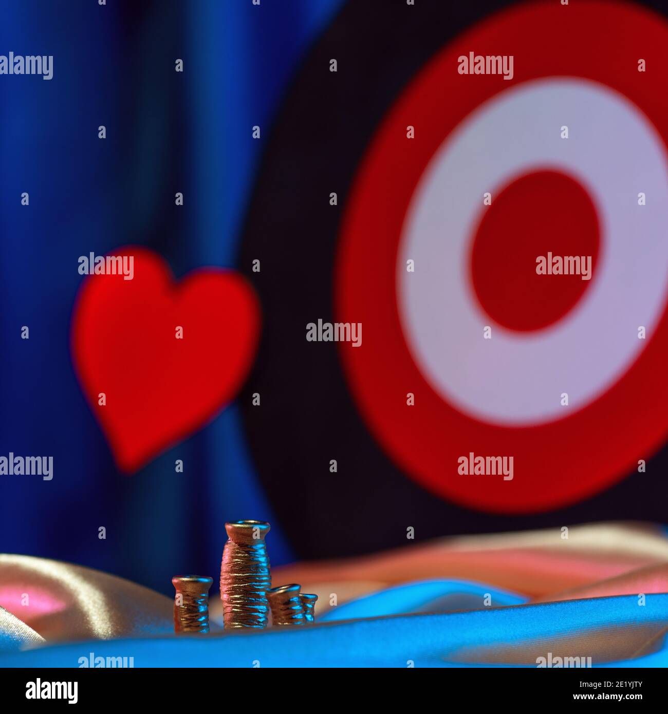 Small golden cupid marks his target with an arrow at the heart ...