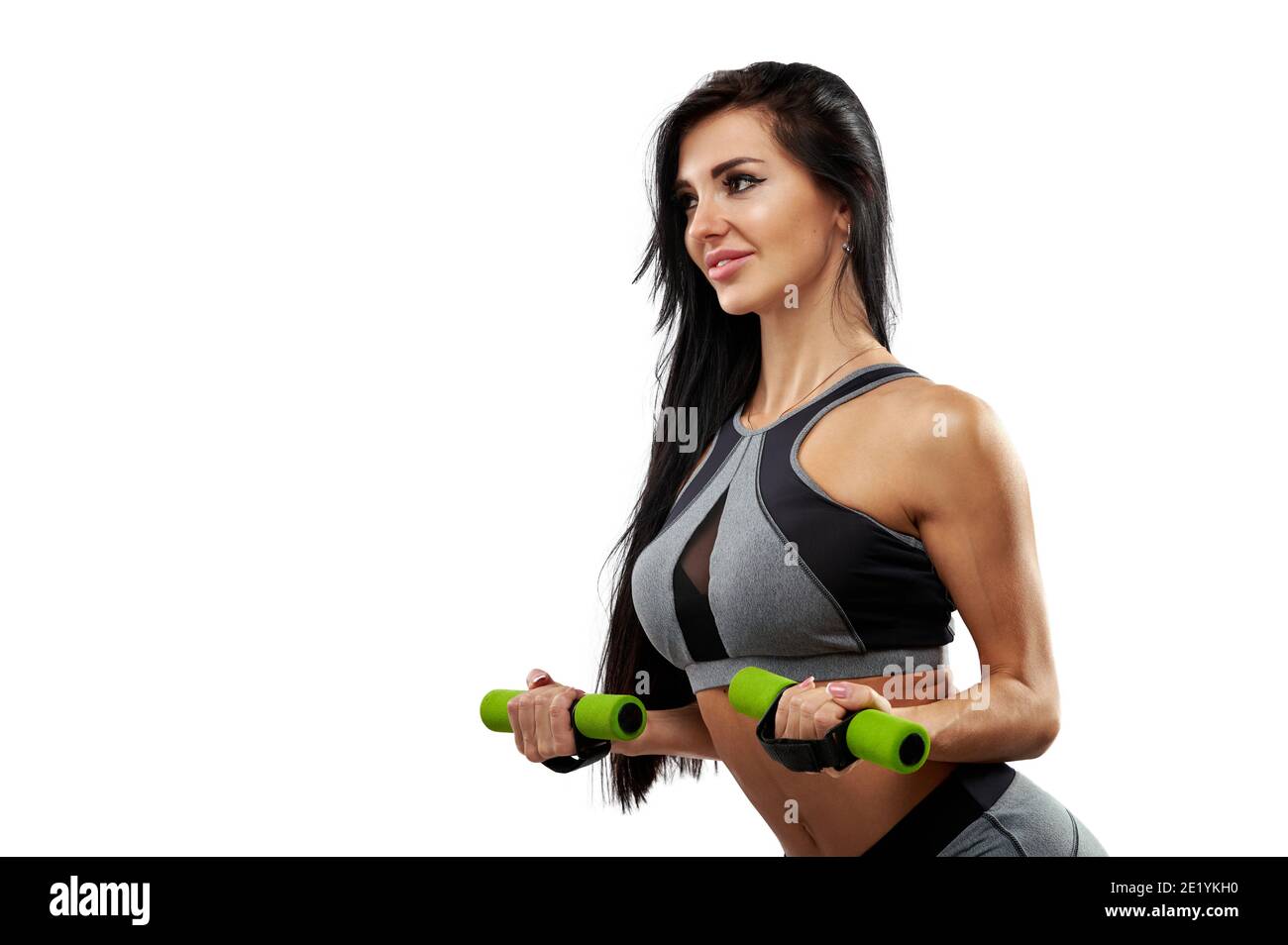 Side portrait of an attractive muscular build woman exercising with ...