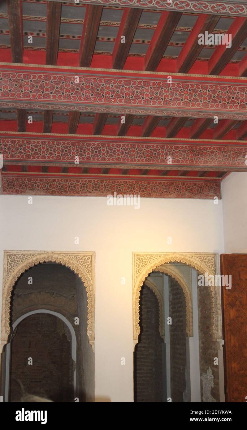 Looking up at a red decorative painted wooden ceiling with intricate ...