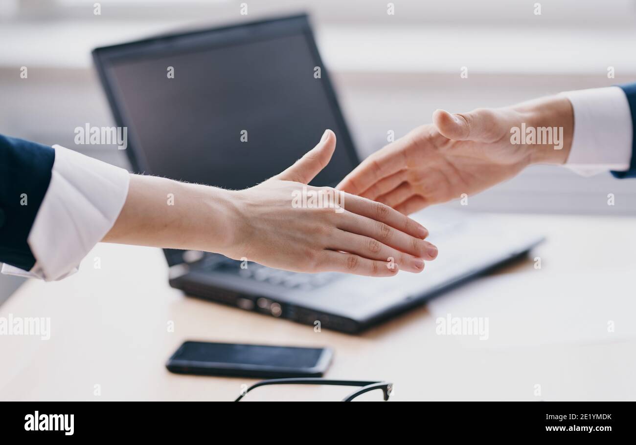 Handshake gesturing hands laptop office work window Stock Photo - Alamy