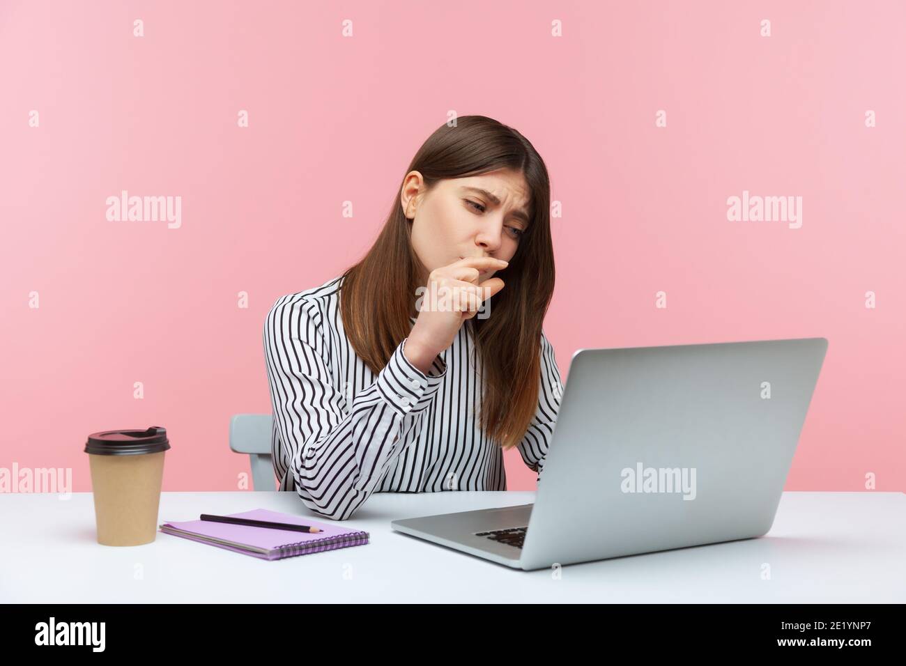 Disappointed woman office worker showing a little bit gesture to laptop ...