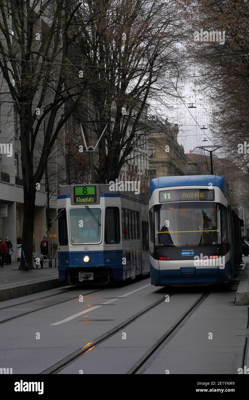Two trams in blue color passing each other in opposite directions in ...