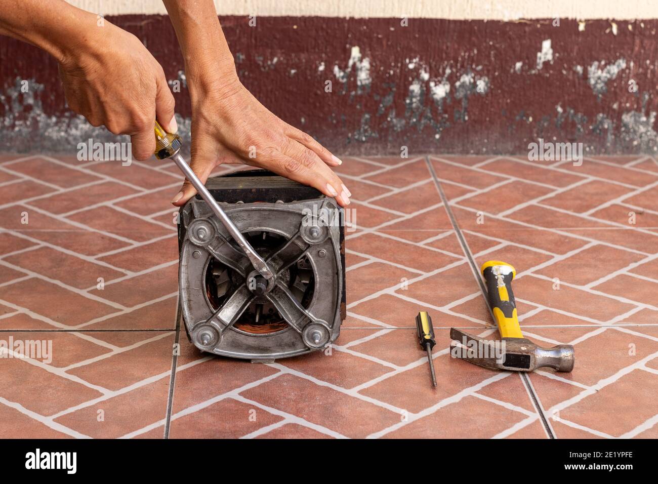 washing machine motor repair , mechanic working on electric engine ...