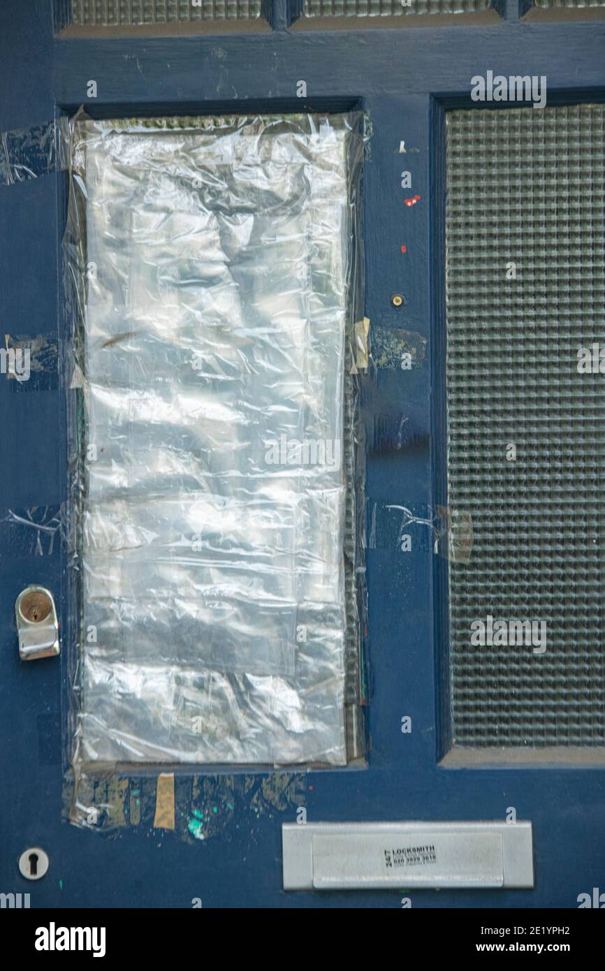 A temporary repair on a broken window following a break in Stock Photo ...