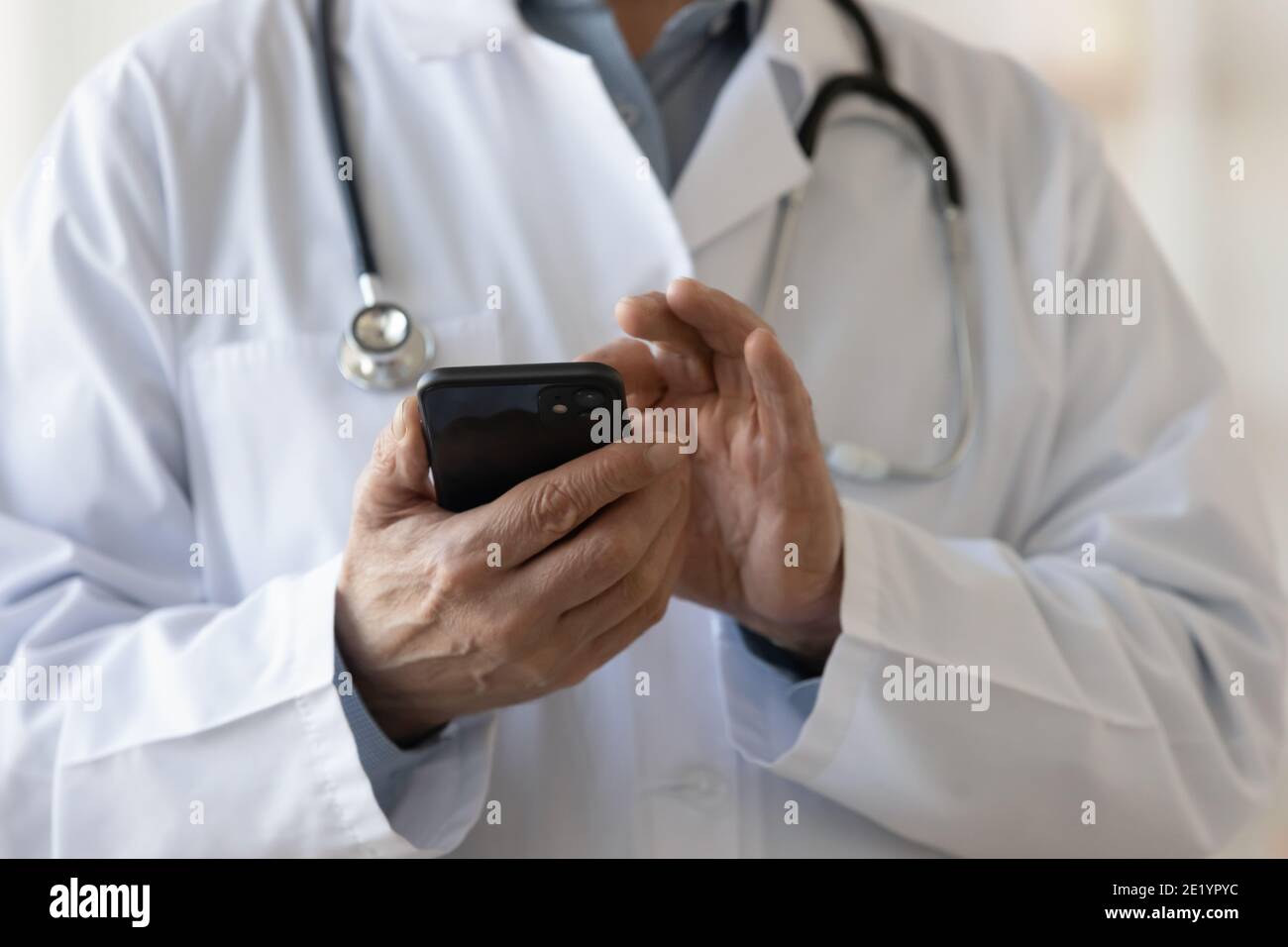 Doctor using computer and smartphone hi-res stock photography and ...
